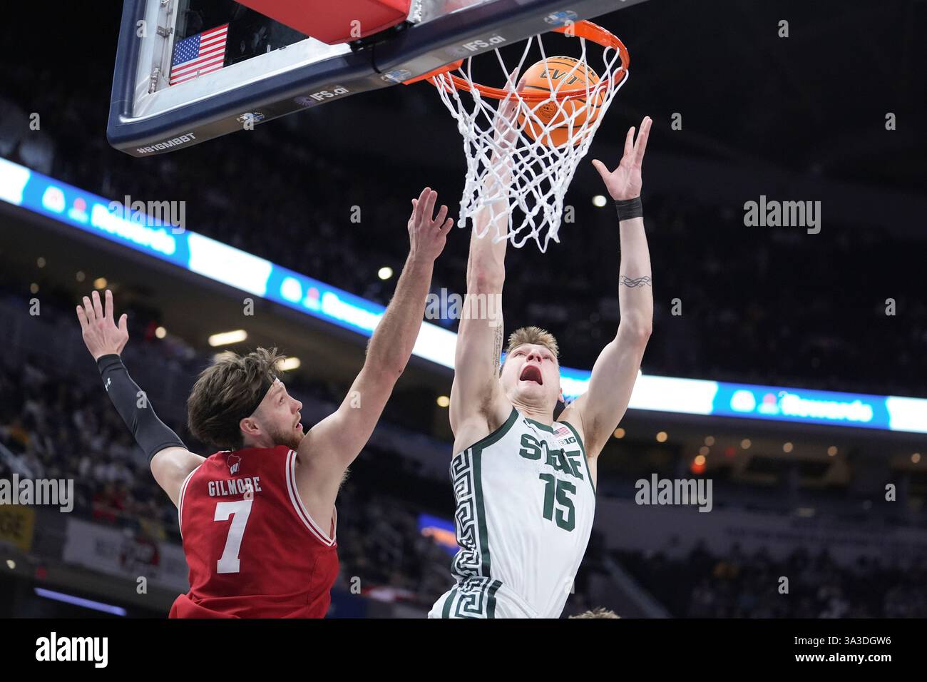 Michigan State center Carson Cooper (15) shoots on Wisconsin forward ...