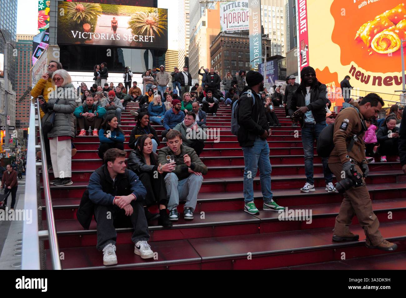 People are seen on the red stairs in Times Square, Manhattan, New York ...