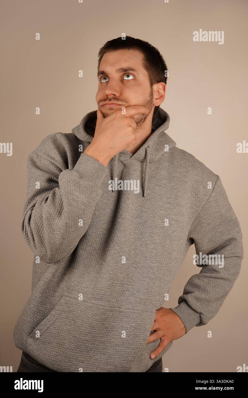 His gaze and expression show focus and contemplation. This pose evokes ...