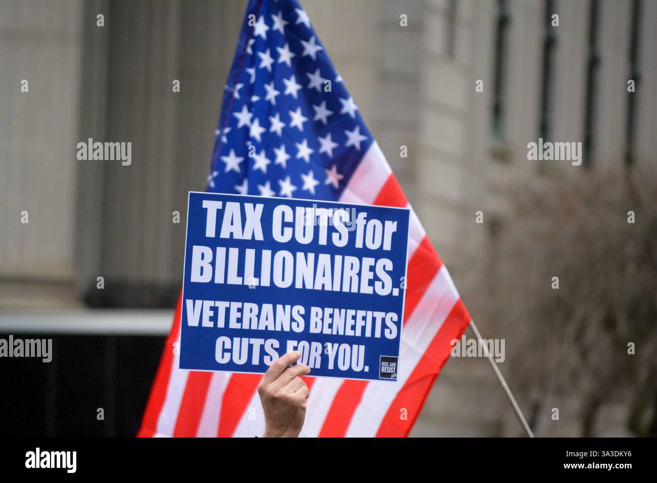 Sign at a Stop the Cuts rally against DOGE cuts to federal funding in ...