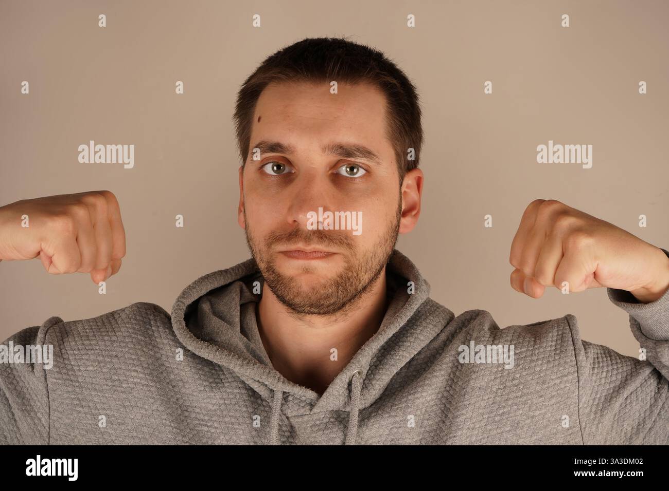 His pose emphasizes his physical strength and confidence. This gesture ...