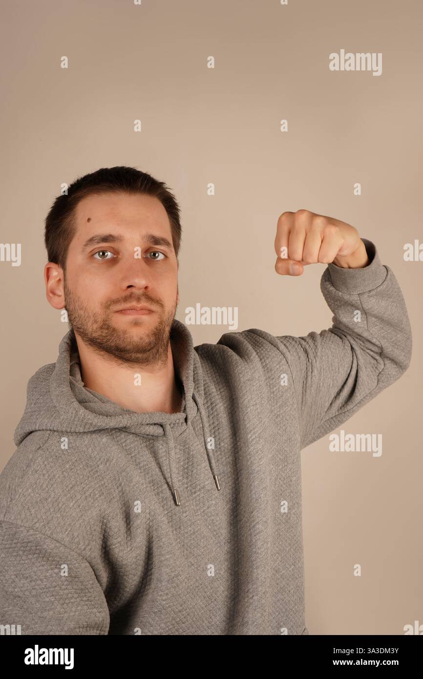 His pose reflects both physical strength and confidence. The smile ...