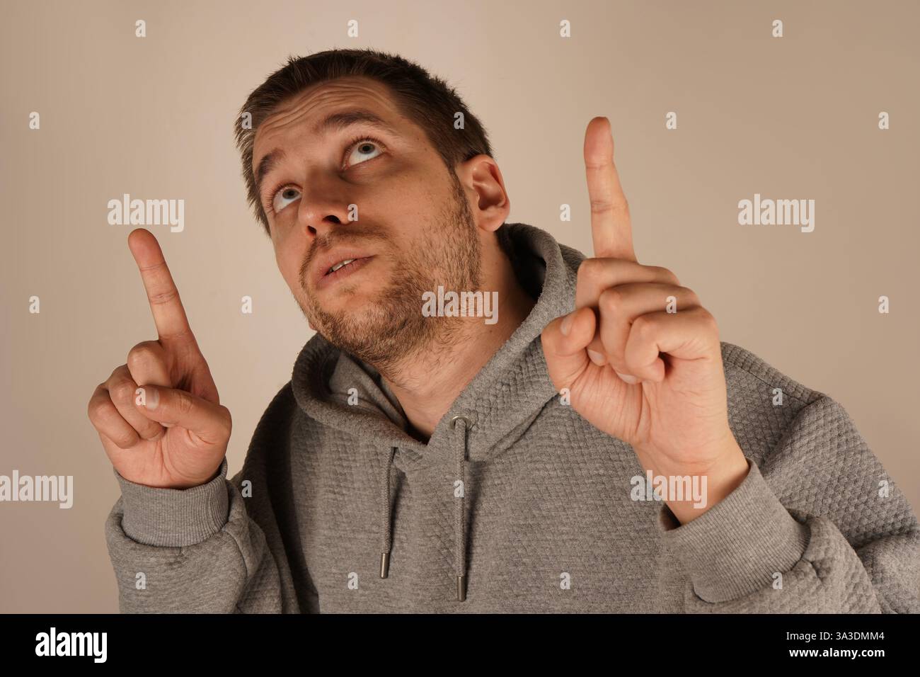 The pose conveys importance and attention. A young man with dark hair ...