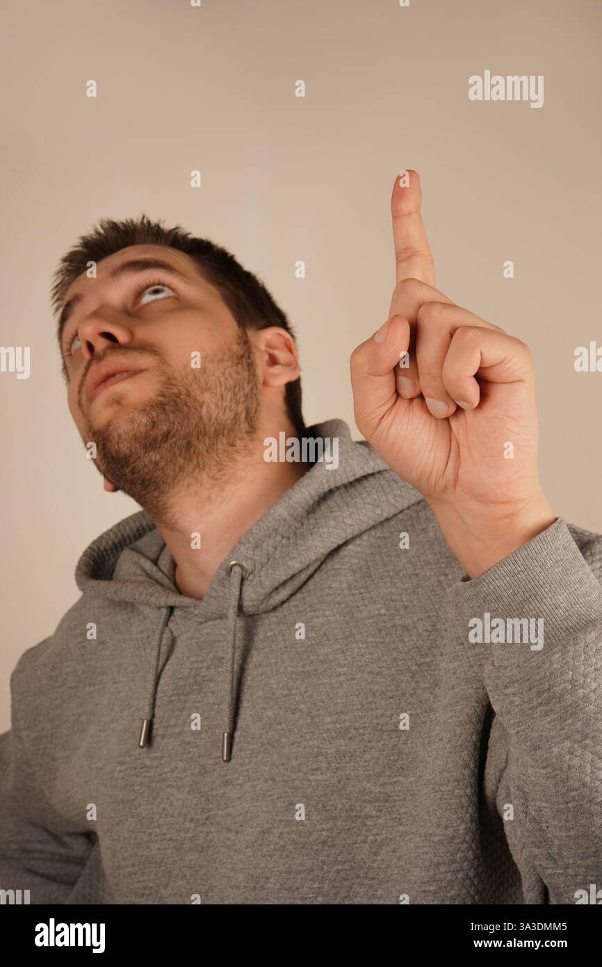 With a single raised finger, the man points upward to underscore a ...