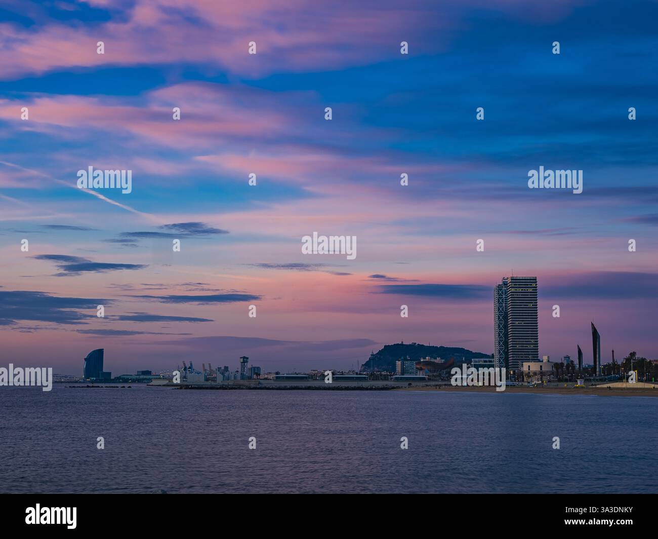 Waves gently lap against the shore as vibrant colors fill the sky ...