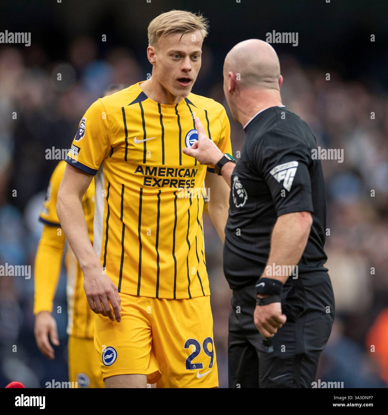 Referee Simon Hooper talk to Jan Paul Van Hecke #29 of Brighton & Hove ...
