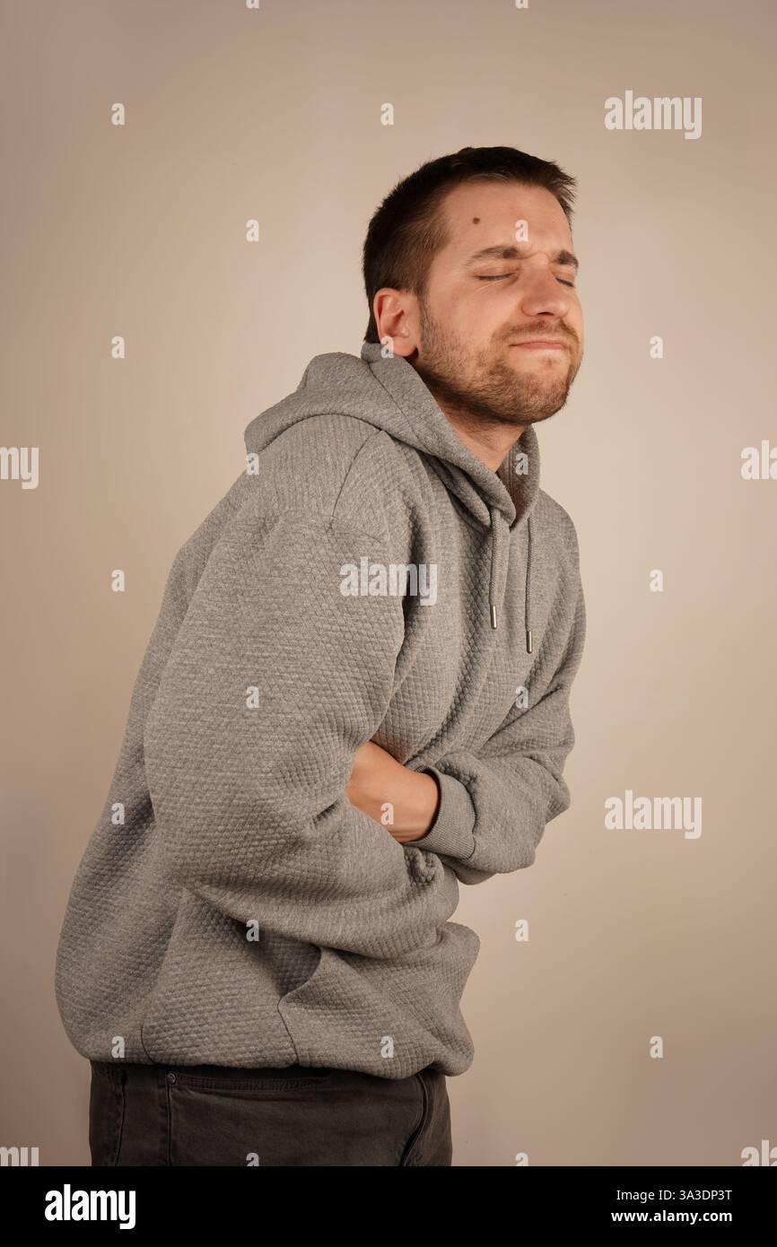 The expression on his face shows discomfort. His physical response ...