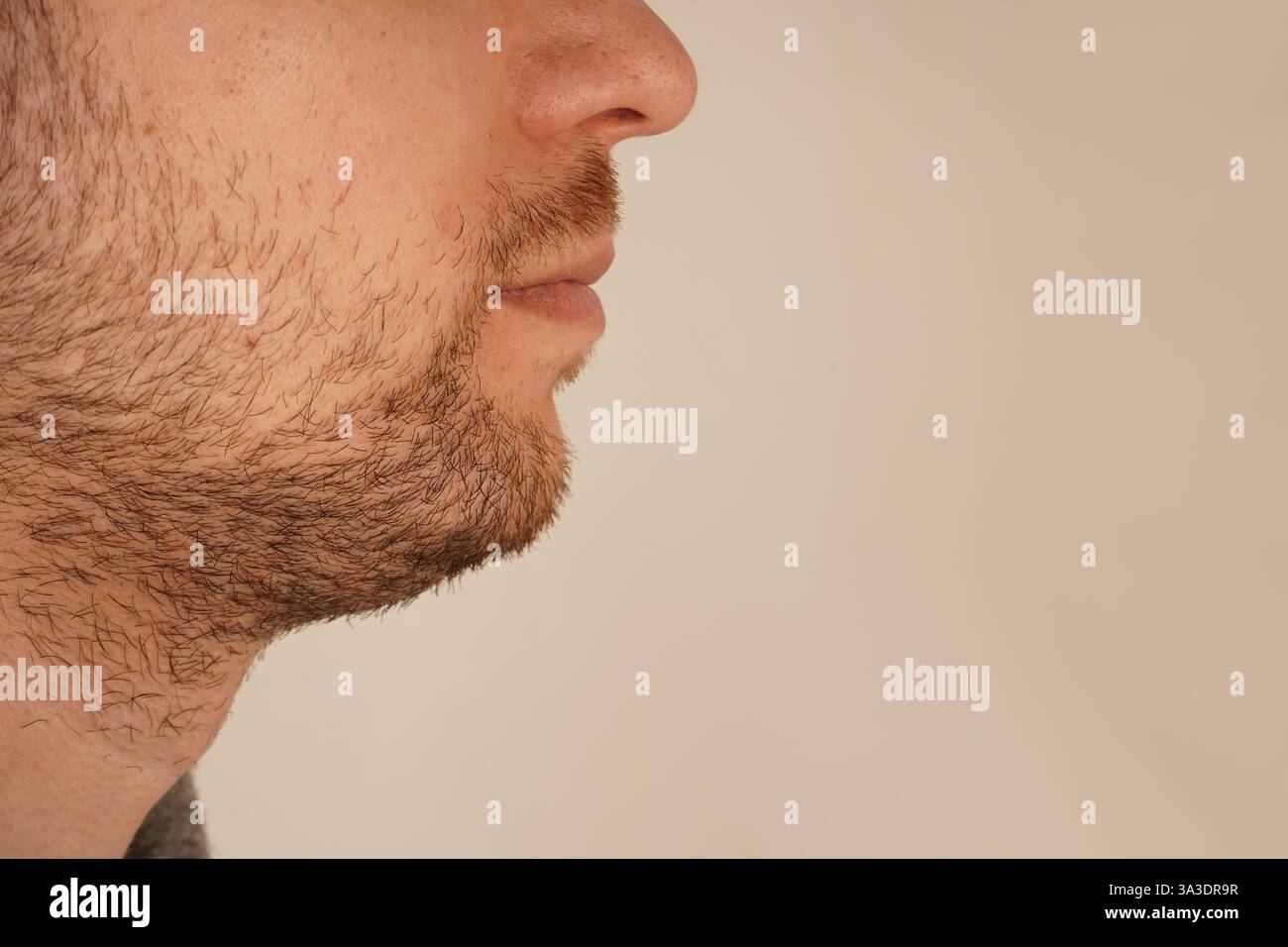 A detailed close-up of a man's chin with subtle stubble, showcasing ...