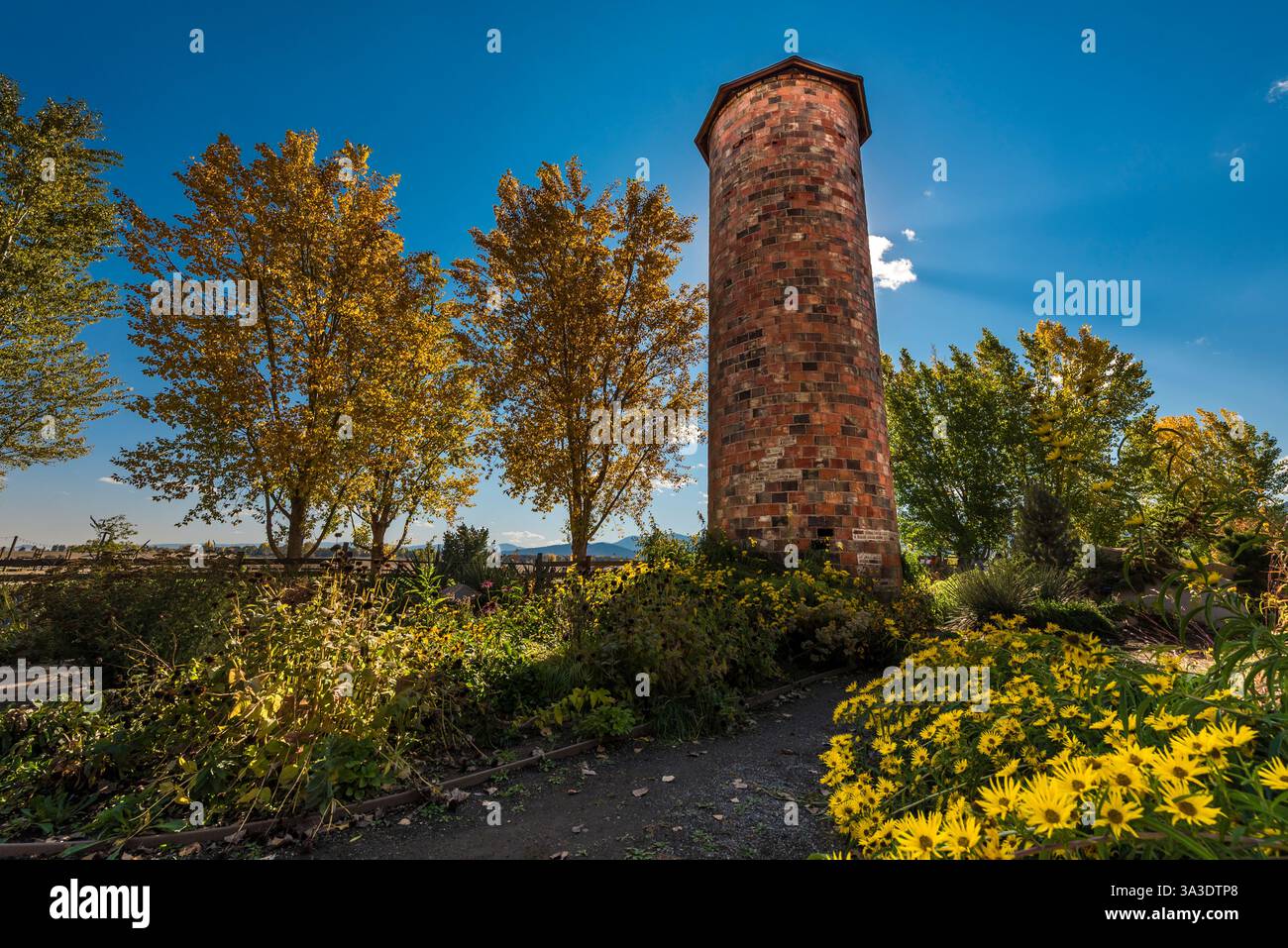 Historic Brick Grain Silo Amid Scenic Meadow and Colorful Autumn ...