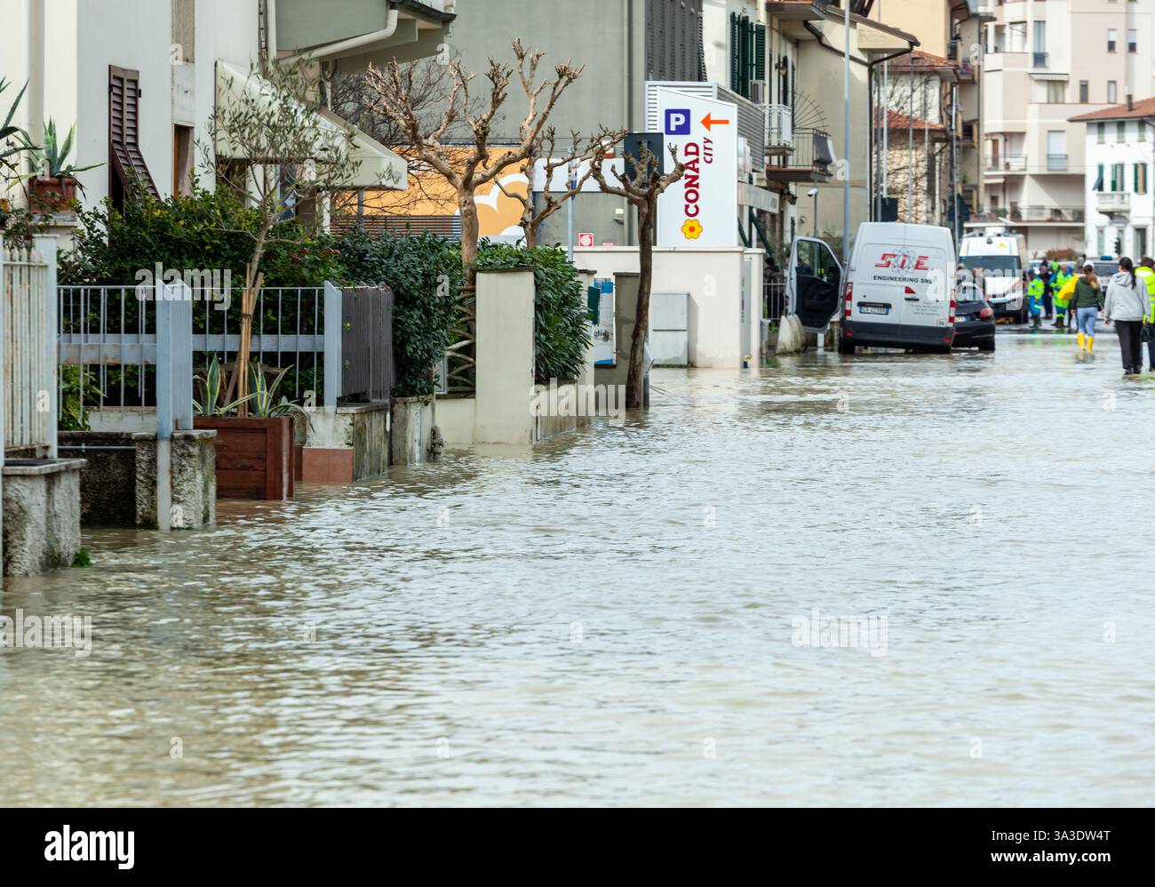 Empoli, Italy - March 15, 2025: Muddy water flowing through the streets ...