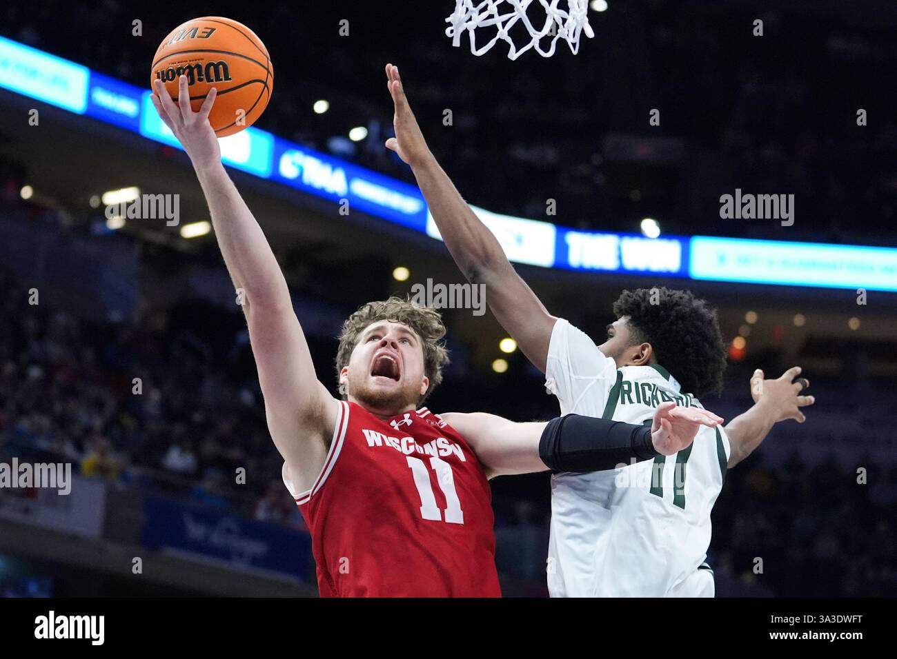 Wisconsin guard Max Klesmit (11) drives on Michigan State guard Jase ...
