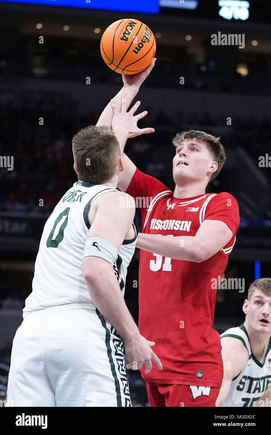 Wisconsin forward Nolan Winter (31) shoots on Michigan State forward ...