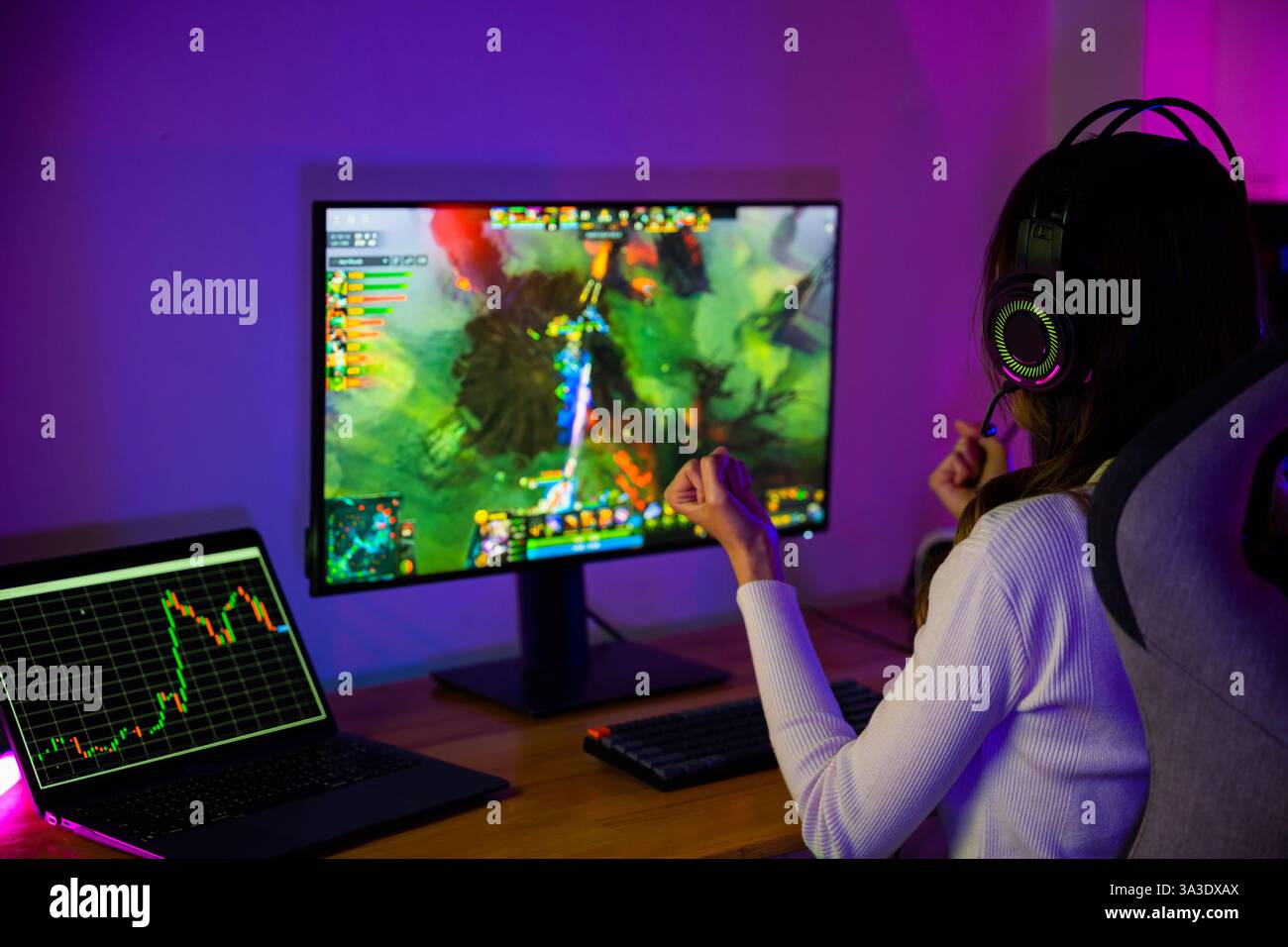 Asian gamer playing online video game excited on desktop computer PC ...