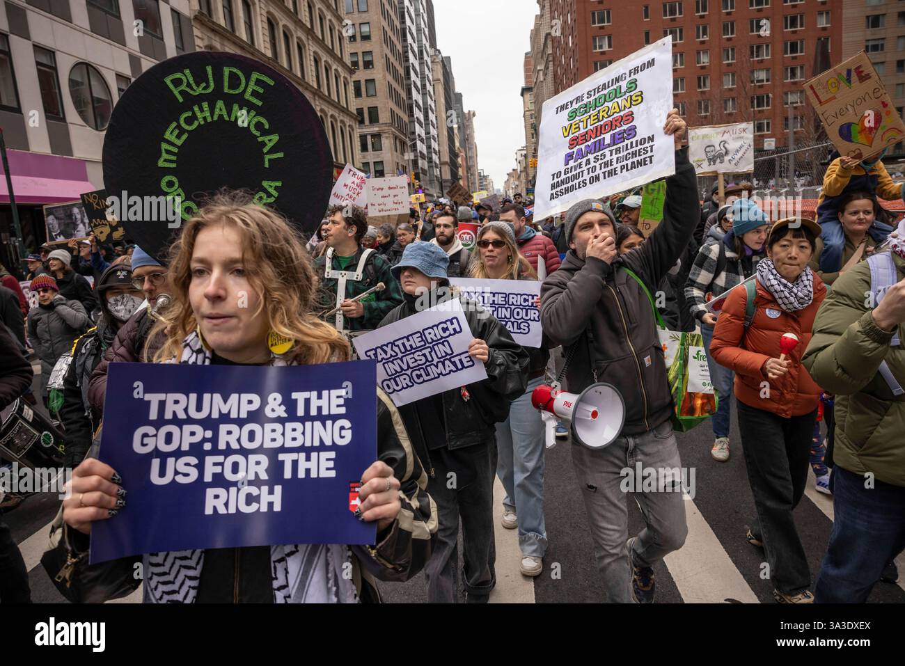 People chant while marching during a "March to Stop the Cuts ...