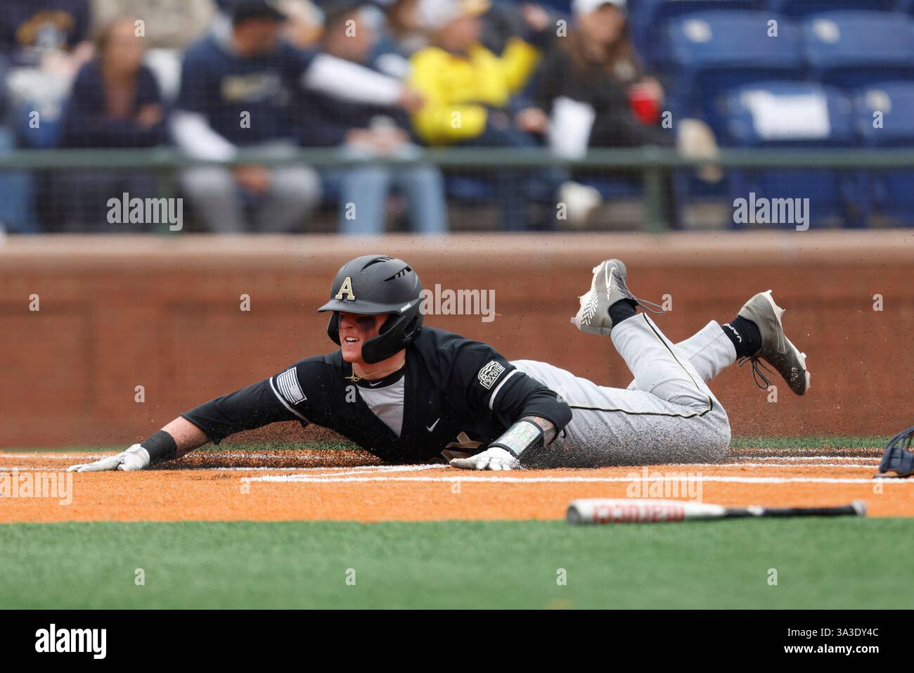 Army catcher Coleson Titus (3) dives safely into home plate during the ...