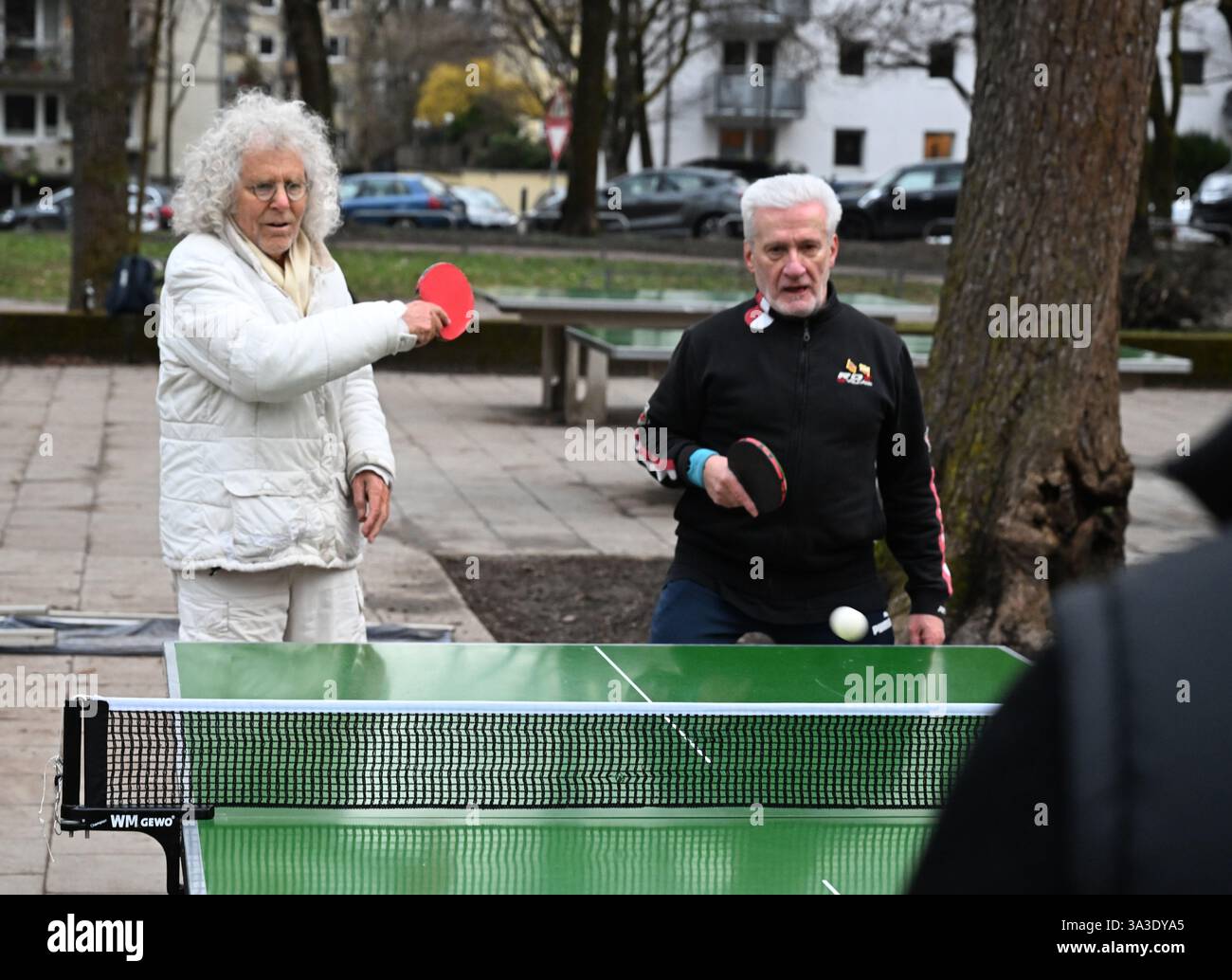 Munich, Germany. 14th Mar, 2025. Rainer Langhans (l) plays table tennis ...
