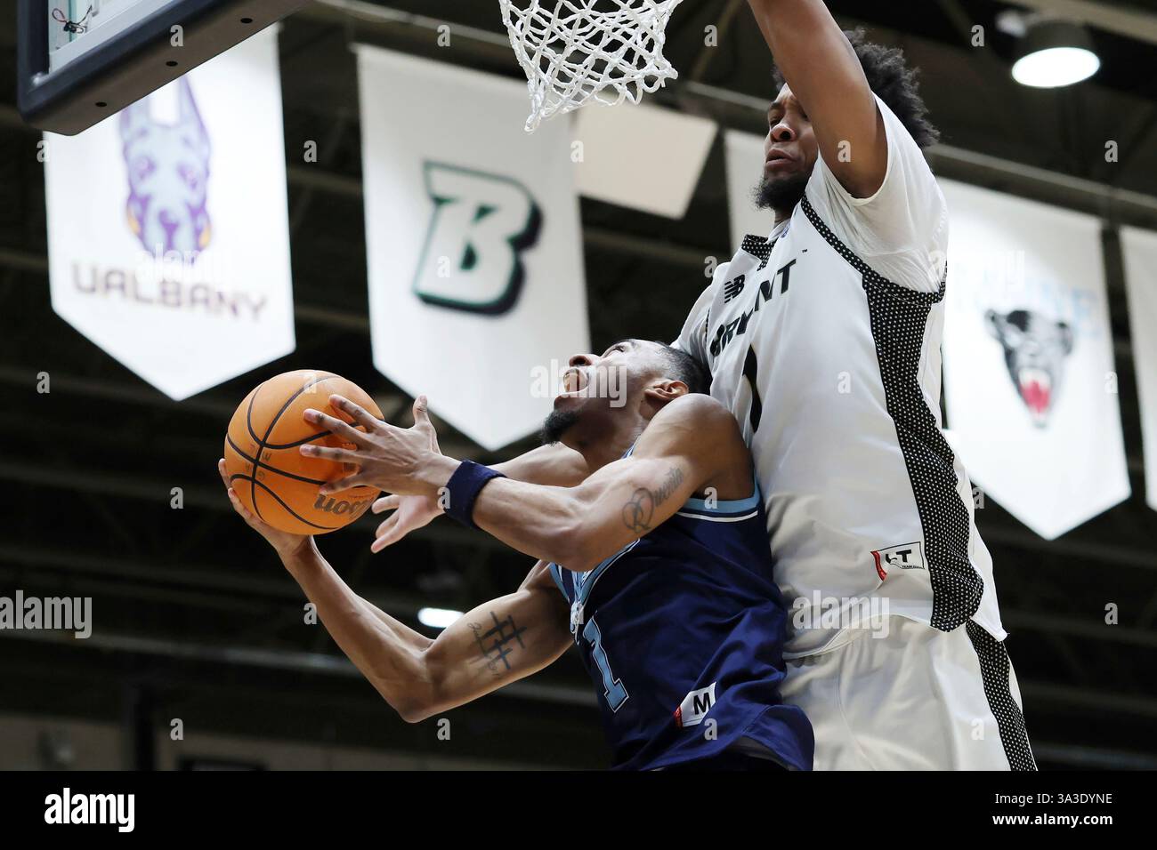 Maine's Kellen Tynes, left, shoots against Bryant's Kvonn Cramer during ...