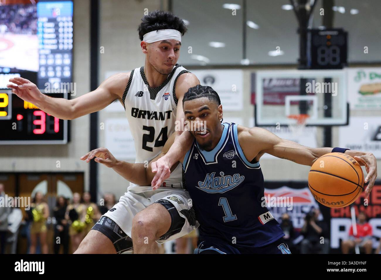 Maine's Kellen Tynes (1) drives past Bryant's Rafael Pinzon (24) during ...