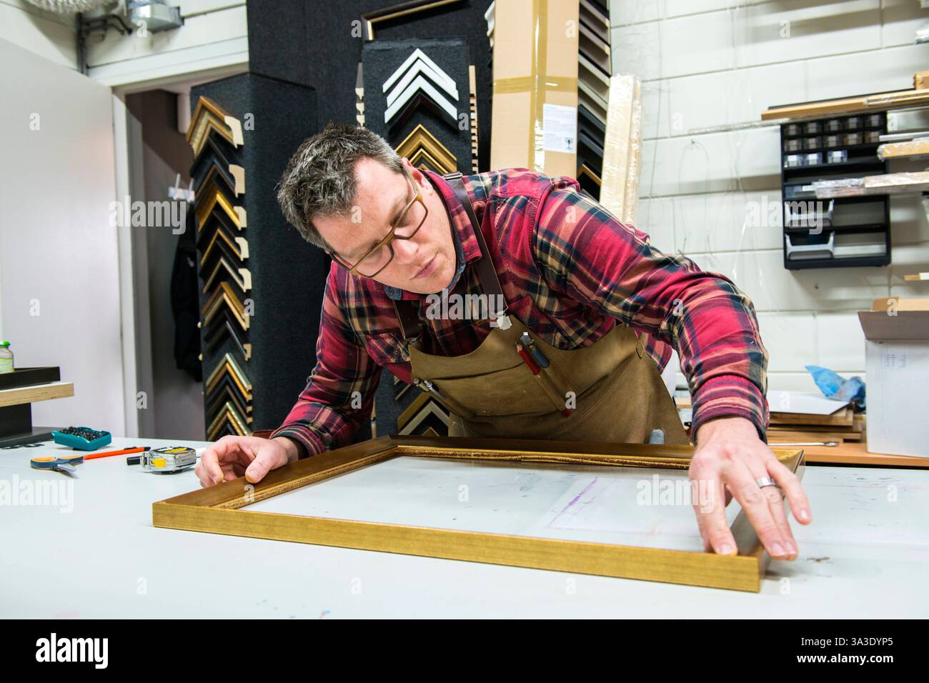 Framemaker inside his workshop Goirle, Netherlands. Mid adult male ...