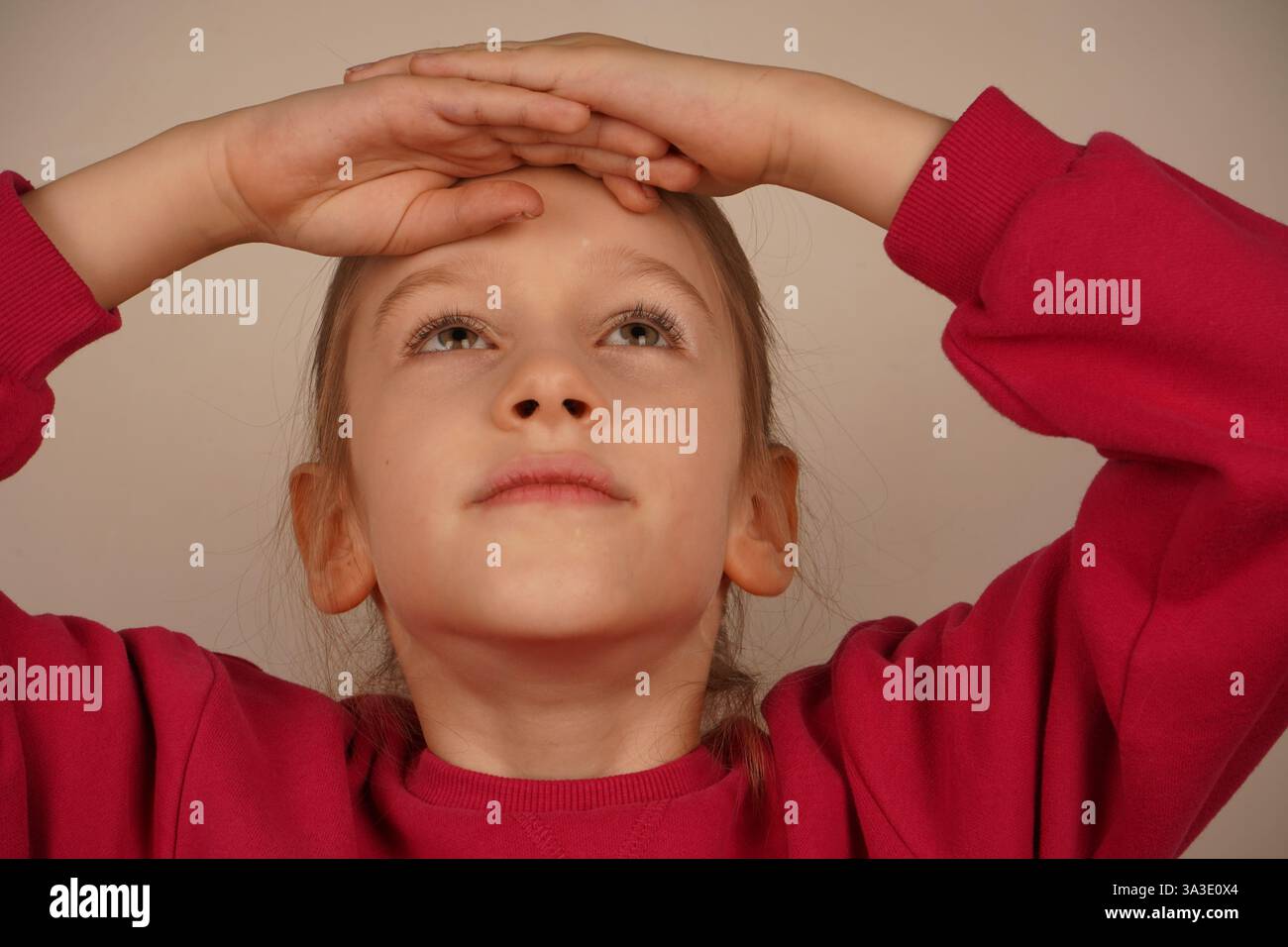 A moment of natural reaction to bright conditions. Shading her eyes ...