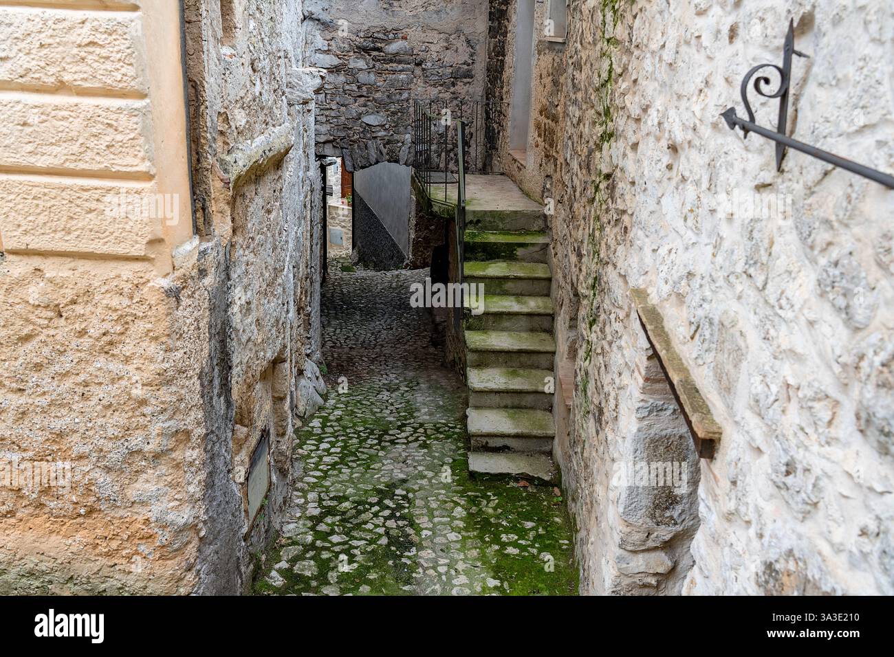 downhill alley paved with stone cobblestones and a mouldy staircase in ...