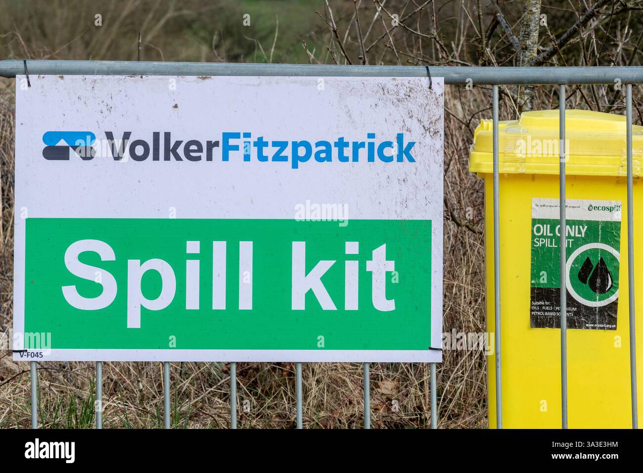 Spill kit sign next to yellow bin for oil spills at a work site ...