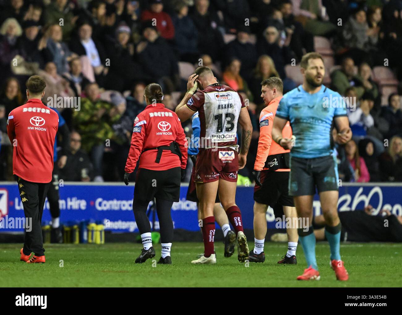 Wigan Warriors' Kaide Ellis leaves the pitch with an injury during the ...