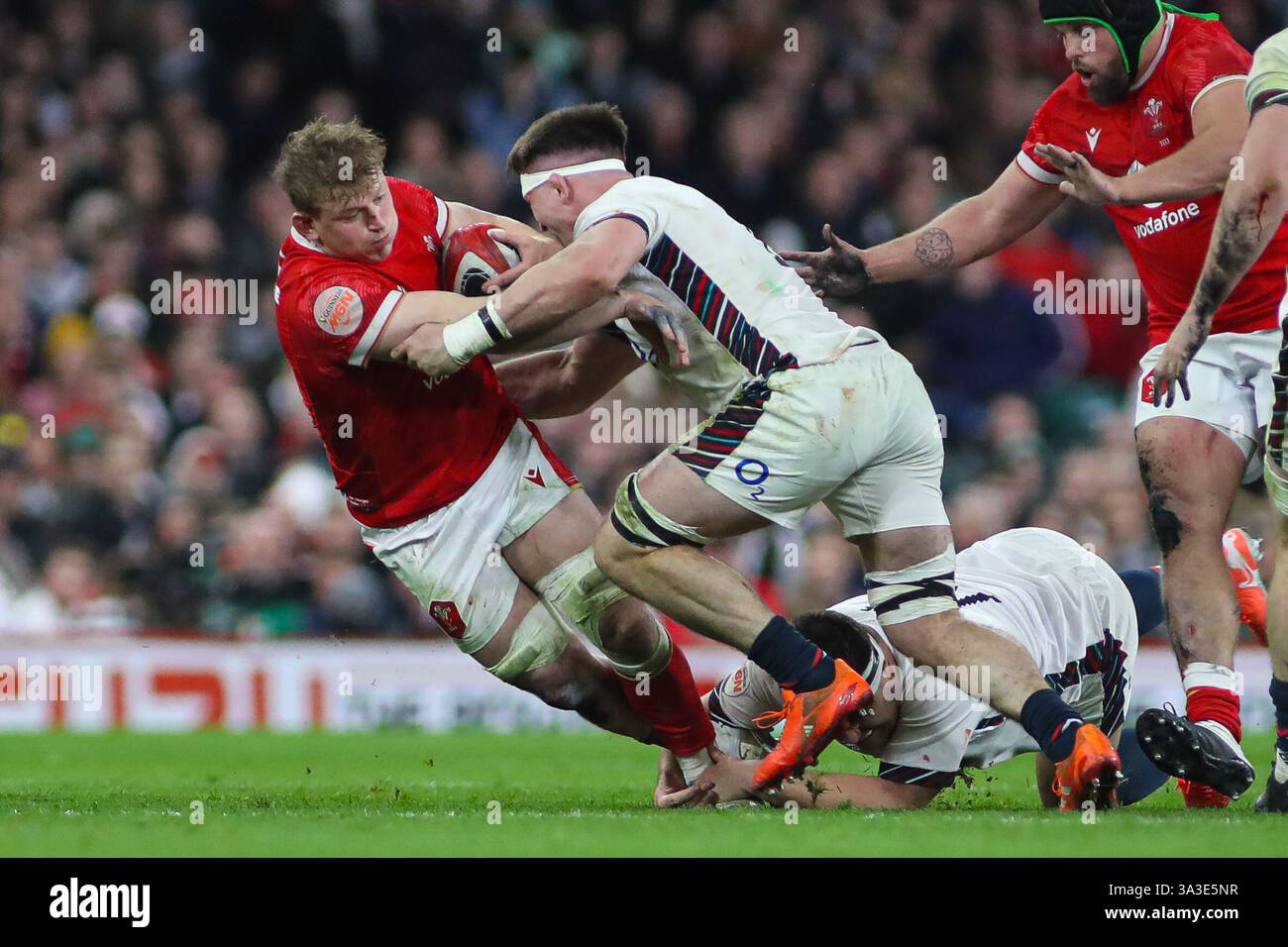 Cardiff, UK. 15th Mar, 2025. Jac Morgan of Wales is tackled by Tom ...