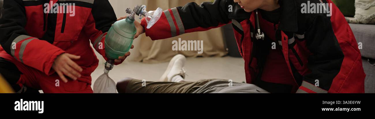Emergency medical professionals assisting unconscious person lying on ...