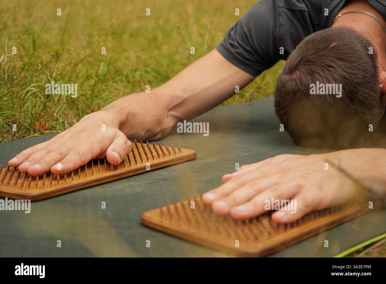 Meditation in the forest: a man sits with his hands resting on the ...
