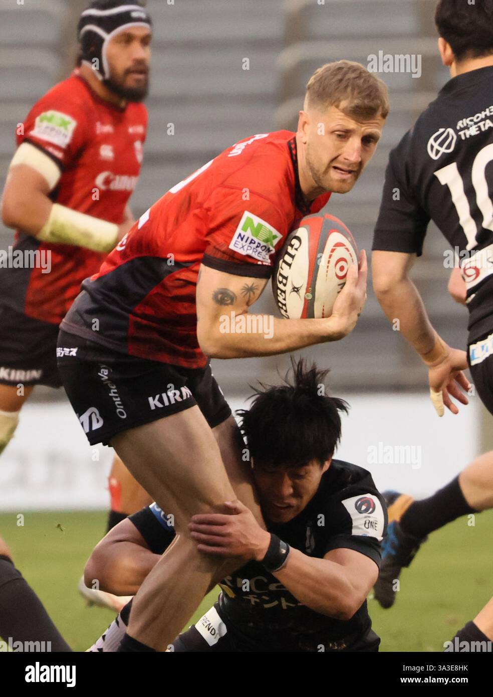 Tokyo, Japan. 15th Mar, 2025. Yokohama Canon Eagles center Brendan Owen carries the ball during ...