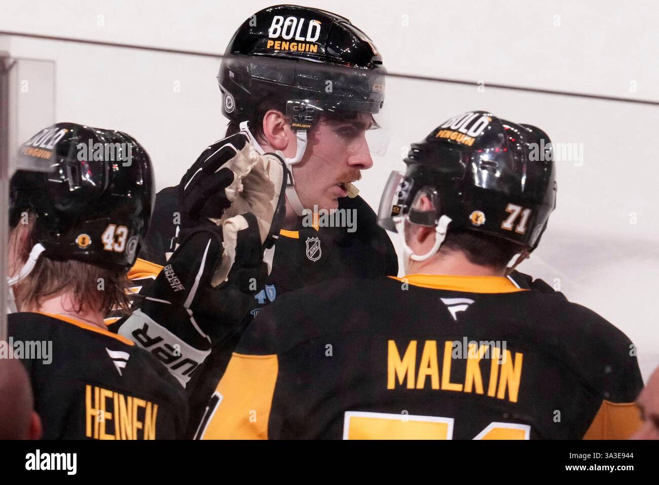 Pittsburgh Penguins' Connor Dewar, center, returns to the bench after ...