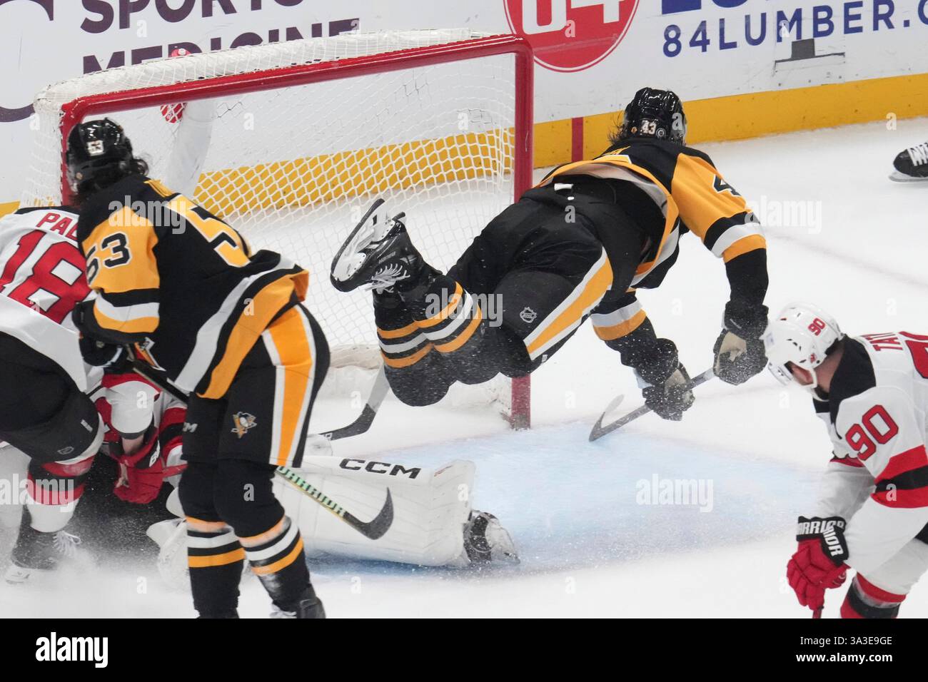 Pittsburgh Penguins' Danton Heinen (43) goes airborne over New Jersey ...