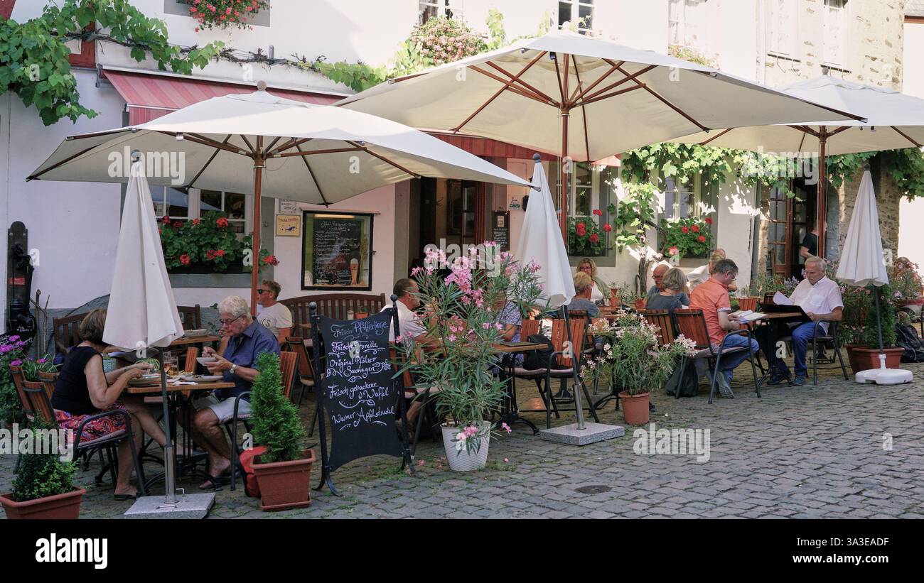Pretty restaurant patio with people enjoying food and drink in a ...