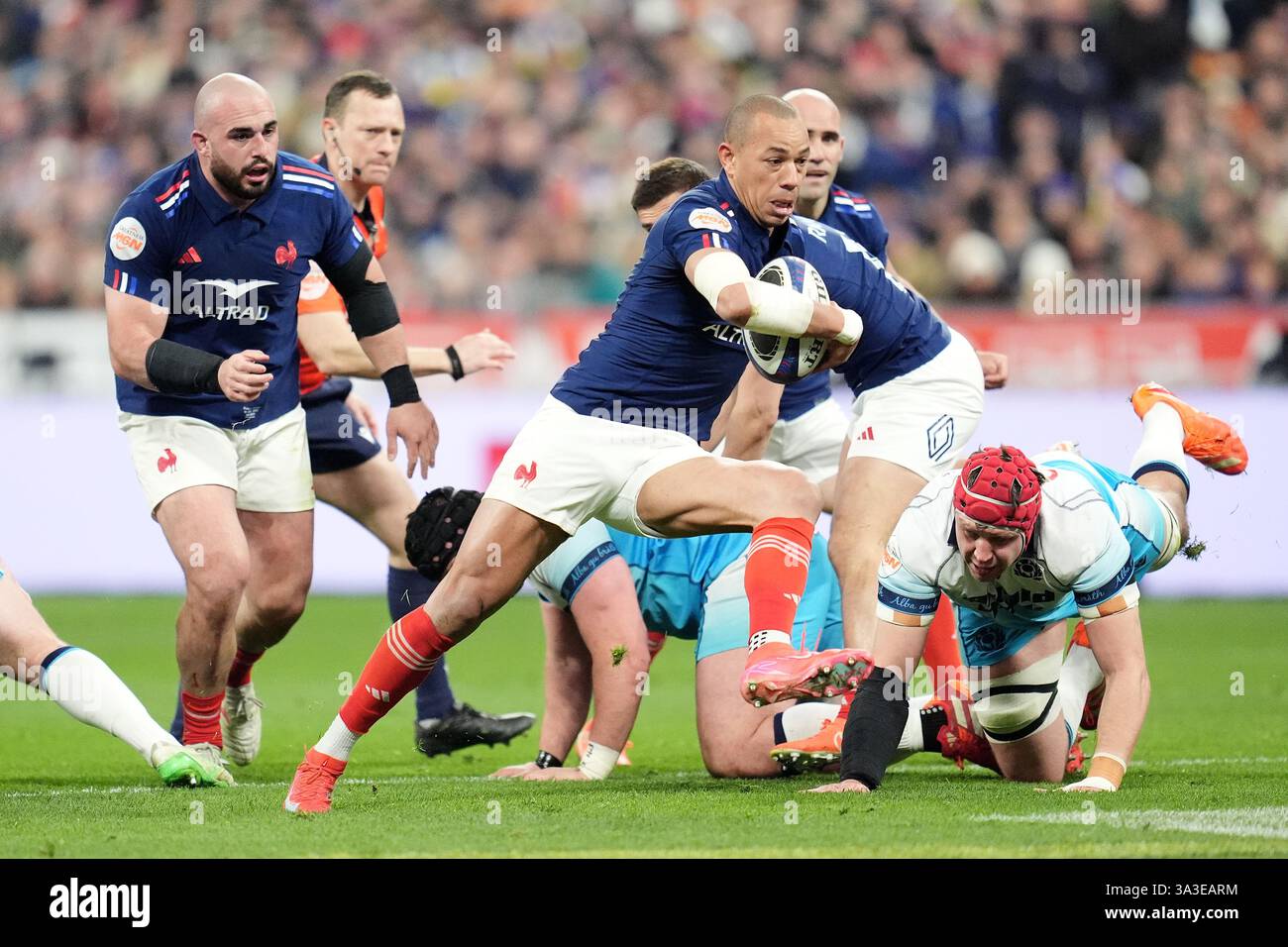 France's Gael Fickou (centre) breaks through before passing to Yoram Moefana to score a try ...