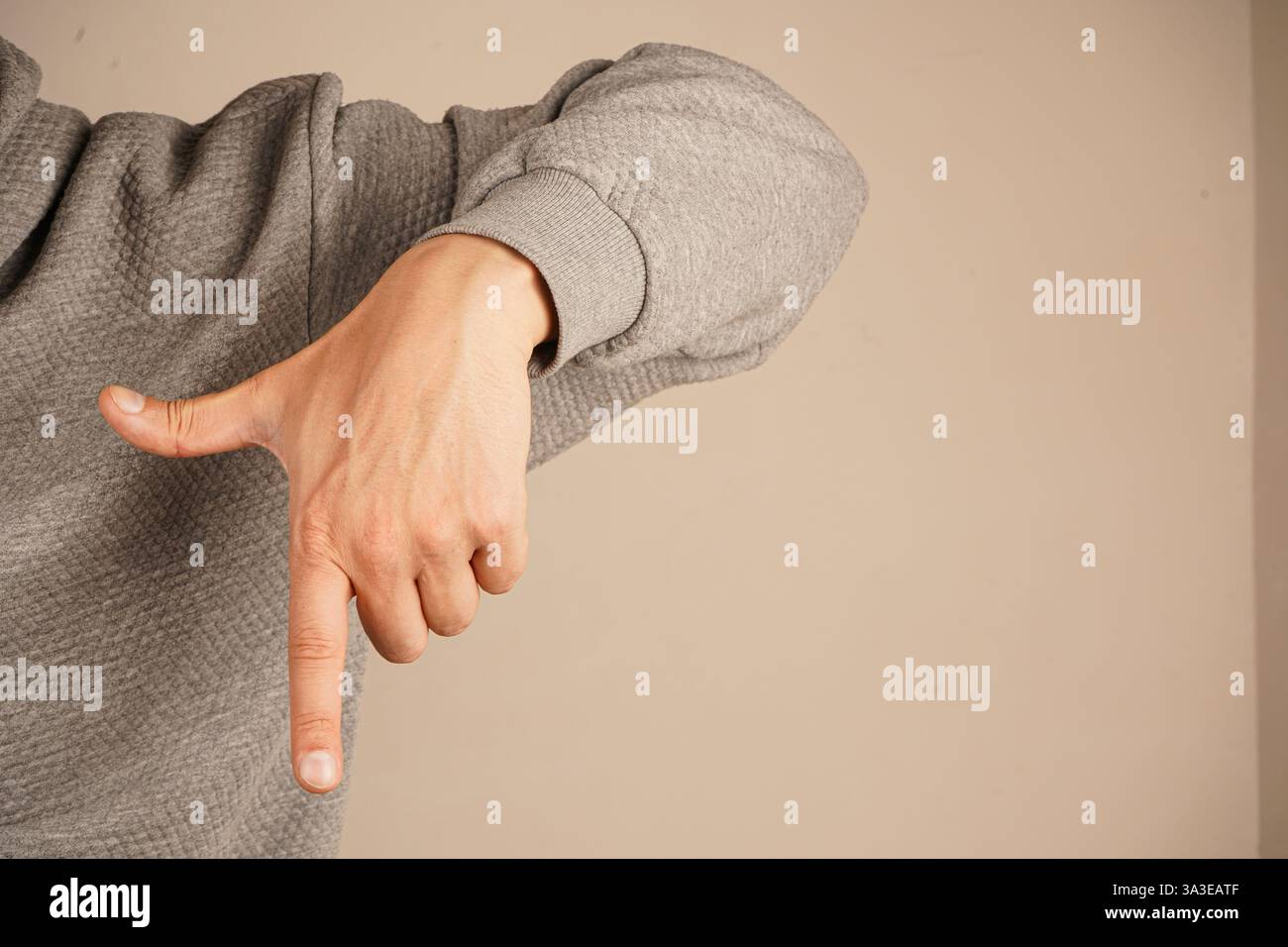 Hand showing a gesture with the index finger pointing and the thumb ...