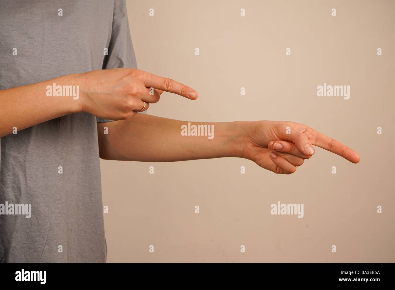 Hands showing a double pointing gesture, directed in opposite ways. The ...
