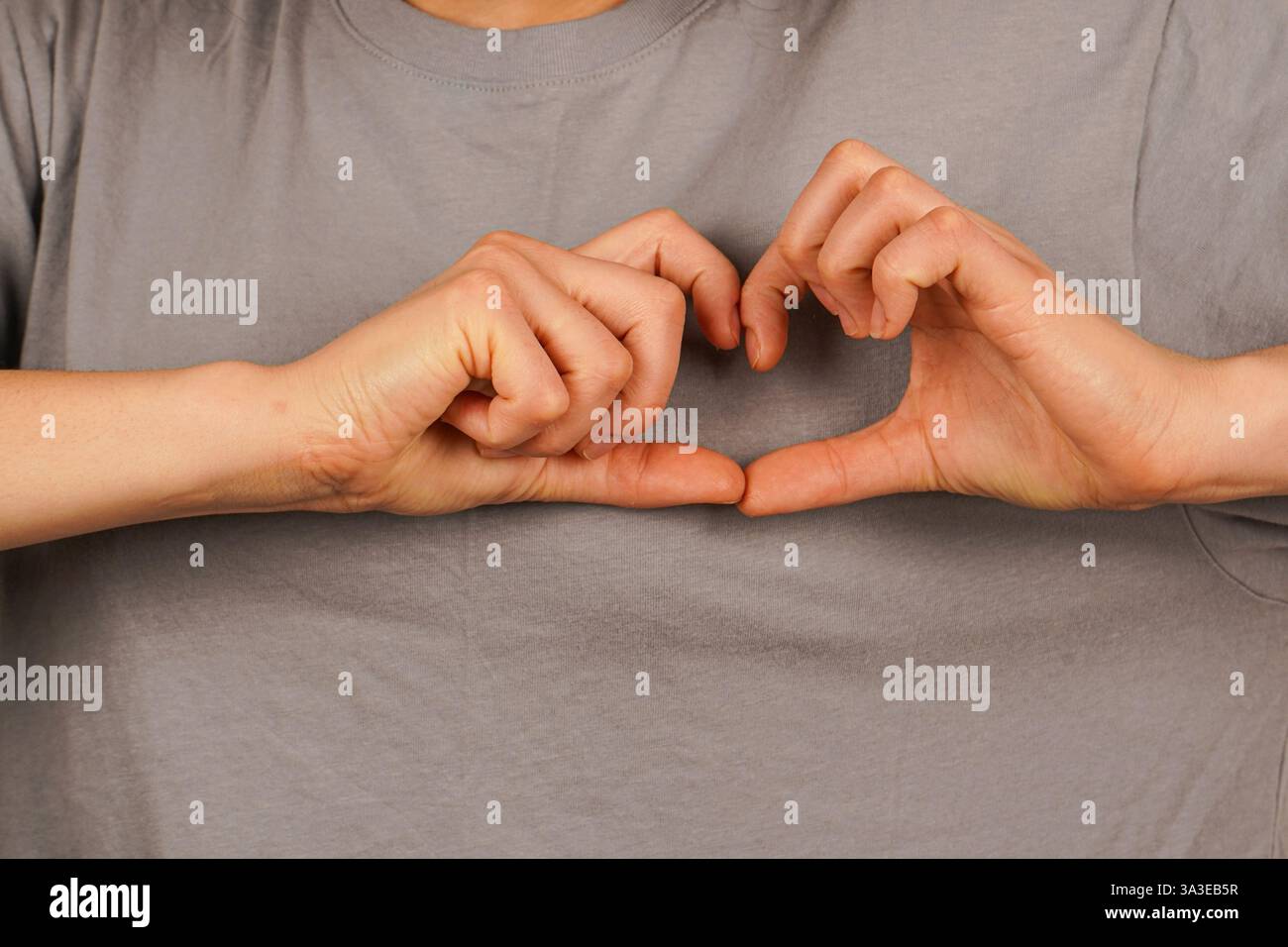 The plain wall highlights the purity of the gesture. A minimalist ...