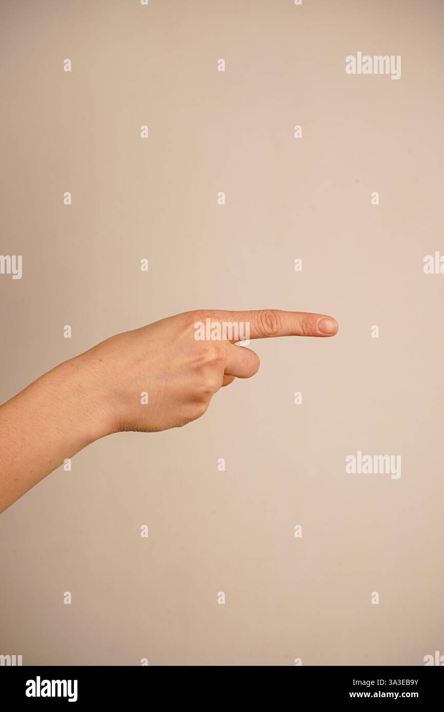 Hand showing a gesture with the index finger pointing and the thumb ...