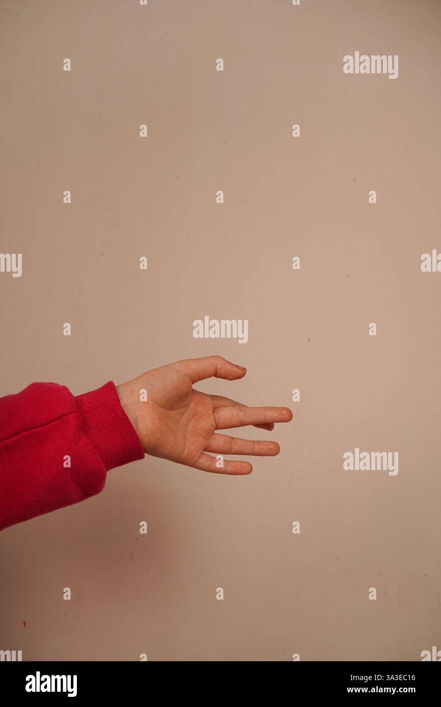 The hand is extended with the palm facing up. On a light background of ...