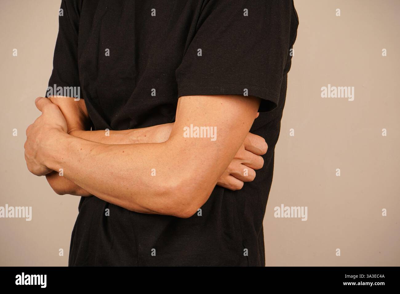 The simplicity of the setting amplifies the body language. A man folds ...