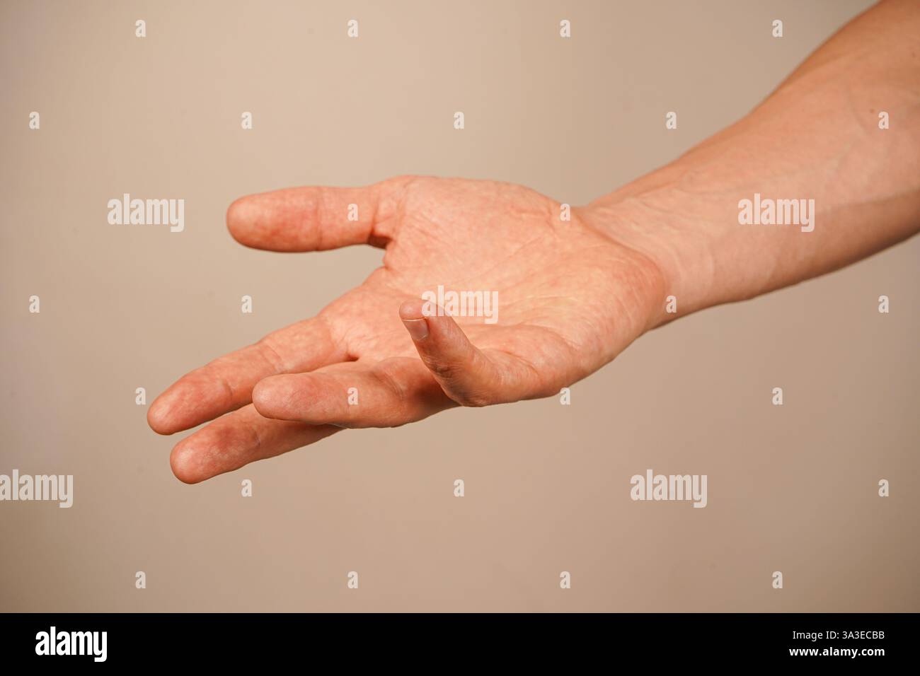 The hand is extended with the palm facing up. On a light background of ...