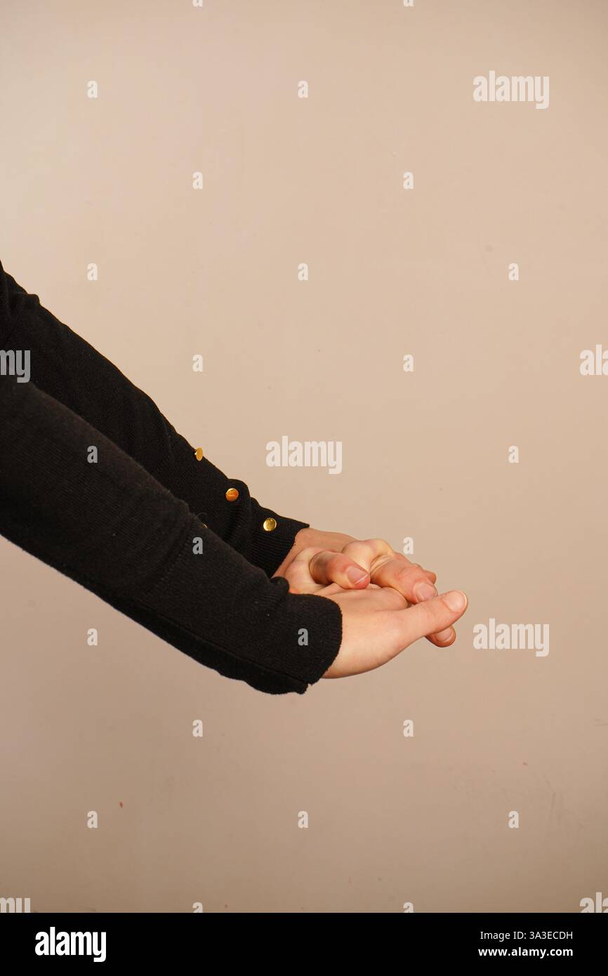 Against a neutral background, the gesture acts as a universal emblem of ...