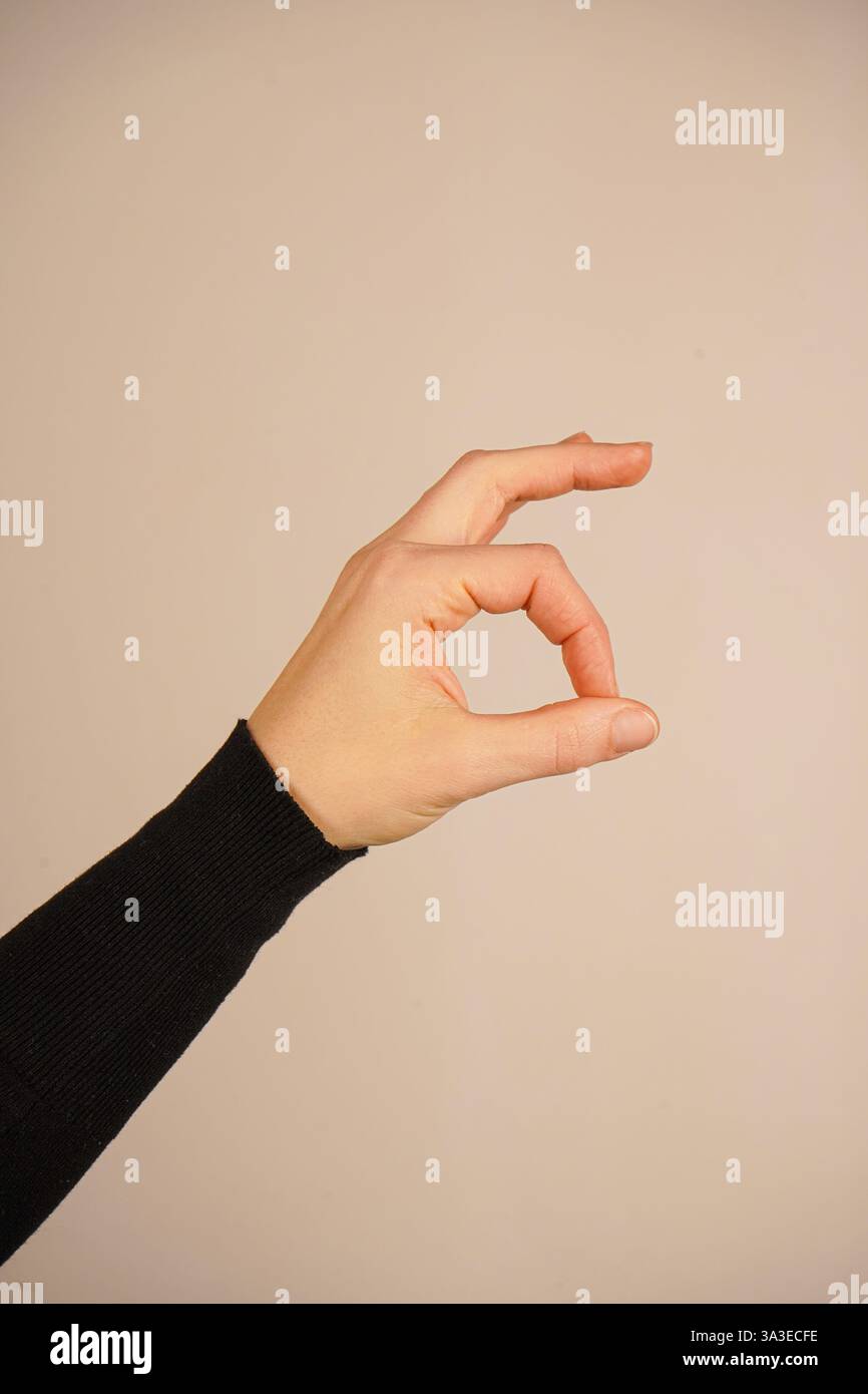 A circle formed by the thumb and forefinger with the fingers pointing ...