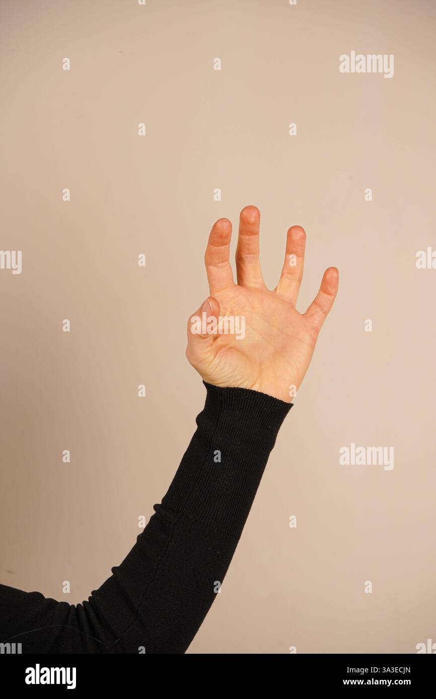 The fingers curled into a claw shape create the impression of a cat's ...