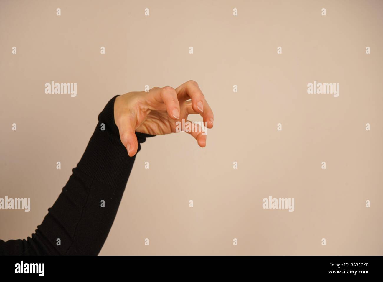 The fingers curled into a claw shape create the impression of a cat's ...