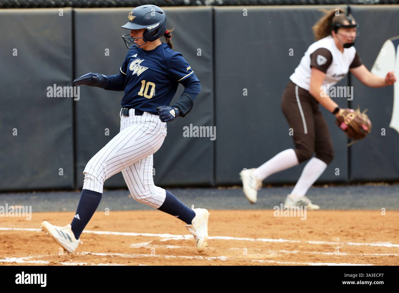 George Washington catcher/utility Allison Heffley (10) scores a run ...