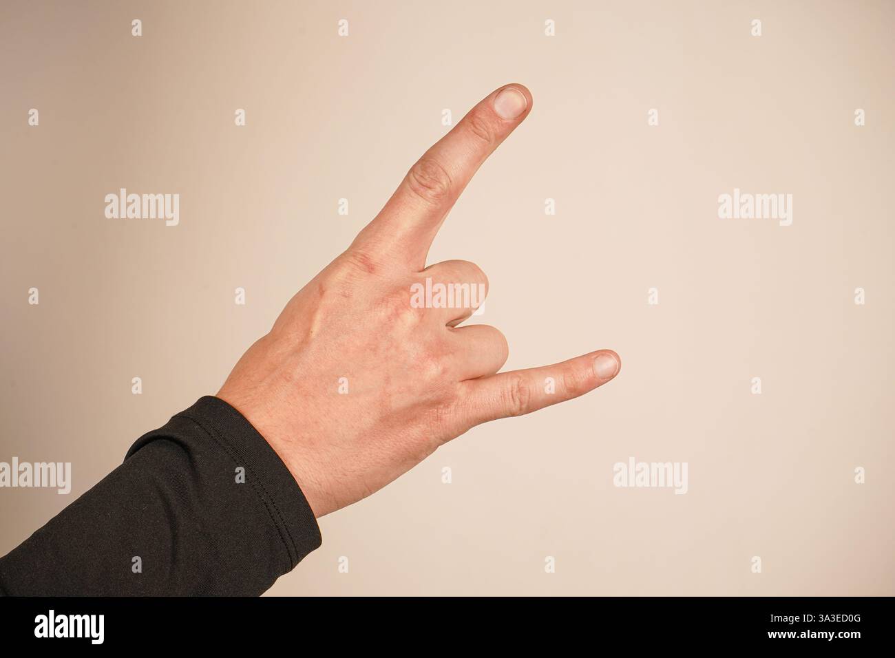 The hand raised in the classic rock and roll gesture symbolizes ...