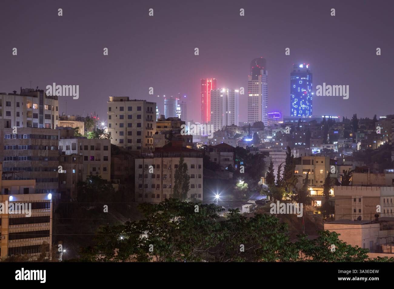 Night panorama of Amman city downtown streets with neon glowing ...