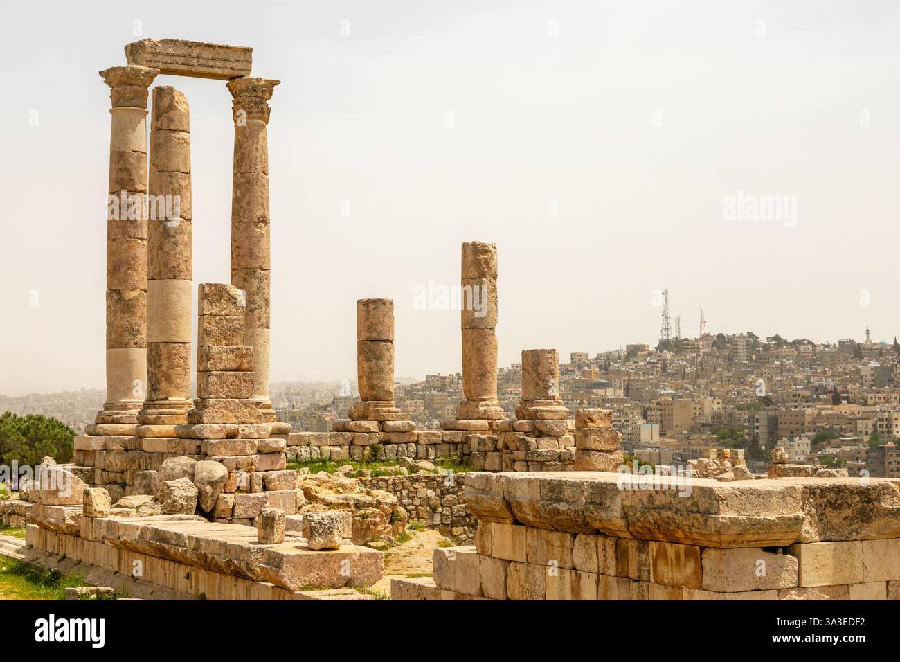 Roman ruined columns and many residential houses densily scattered on ...